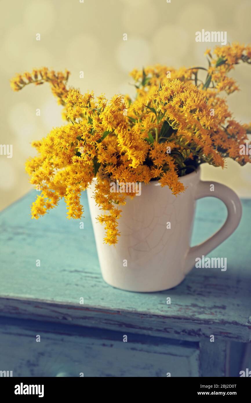 Beautiful mimosa flowers on light blurred background Stock Photo - Alamy