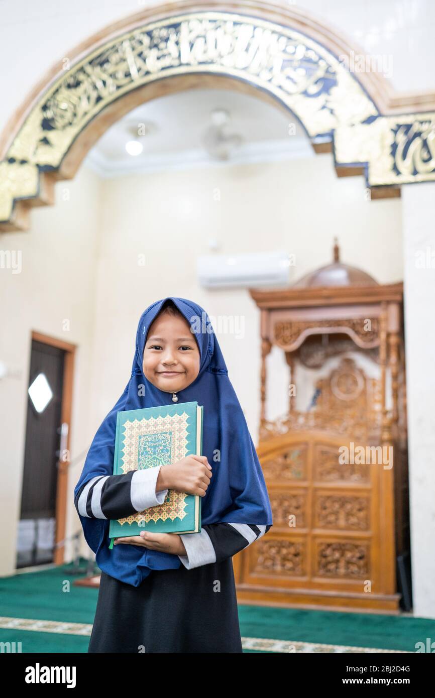 beautiful young kid holding quran praying in the mosque or masjid Stock ...
