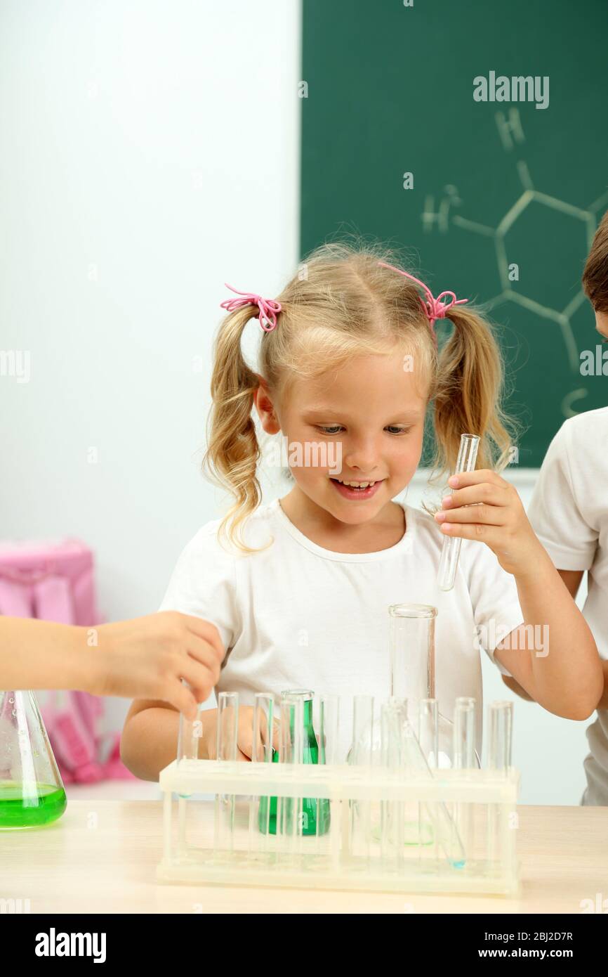 Cute pupil doing biochemistry research in chemistry class Stock Photo ...