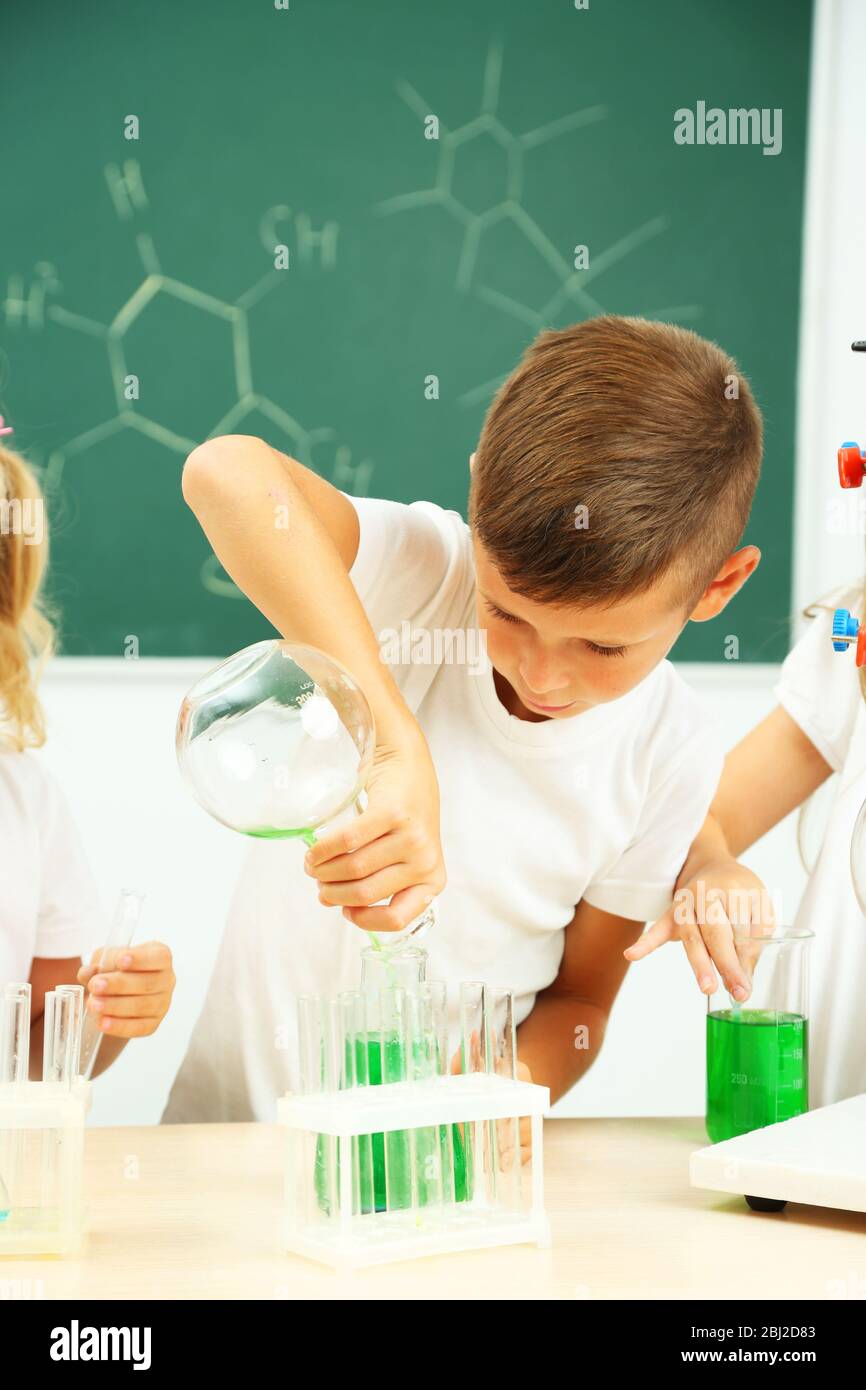 Cute pupil doing biochemistry research in chemistry class Stock Photo ...