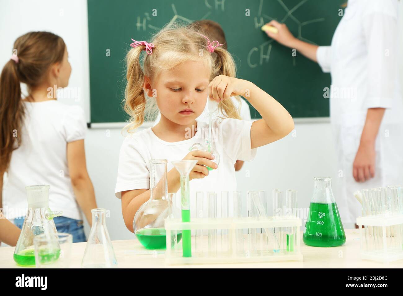 Cute pupil doing biochemistry research in chemistry class Stock Photo ...