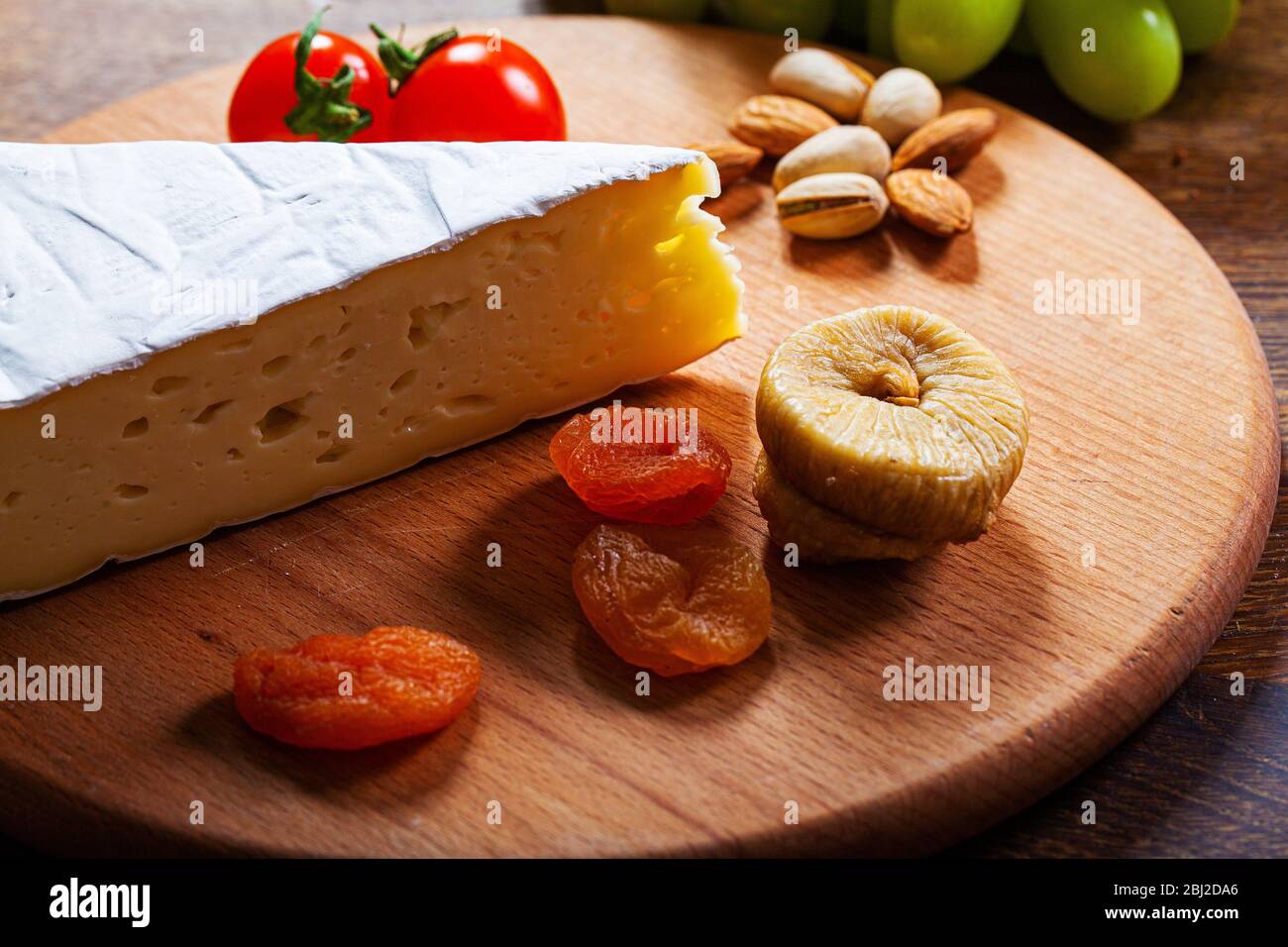 Elite variety of cheese on a wooden board Stock Photo - Alamy