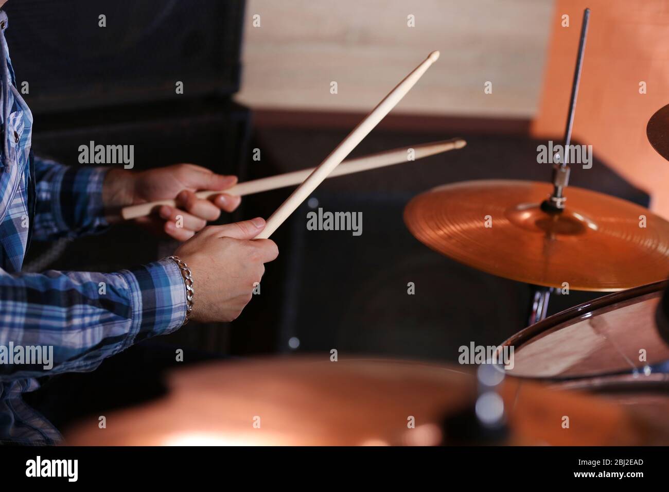 Hand of drummer with sticks and drums, close-up Stock Photo - Alamy