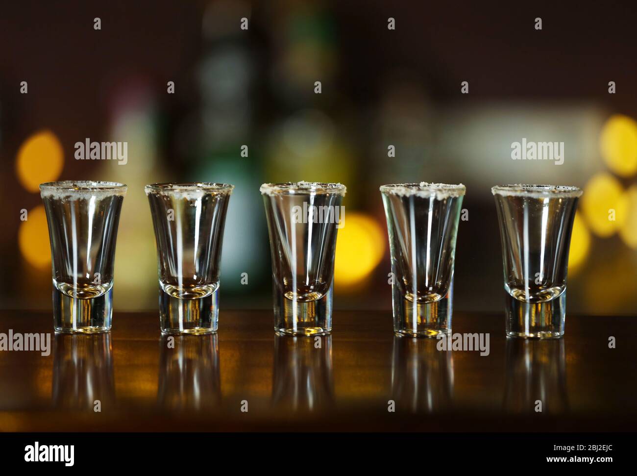 Empty shot glasses on bar counter Stock Photo - Alamy
