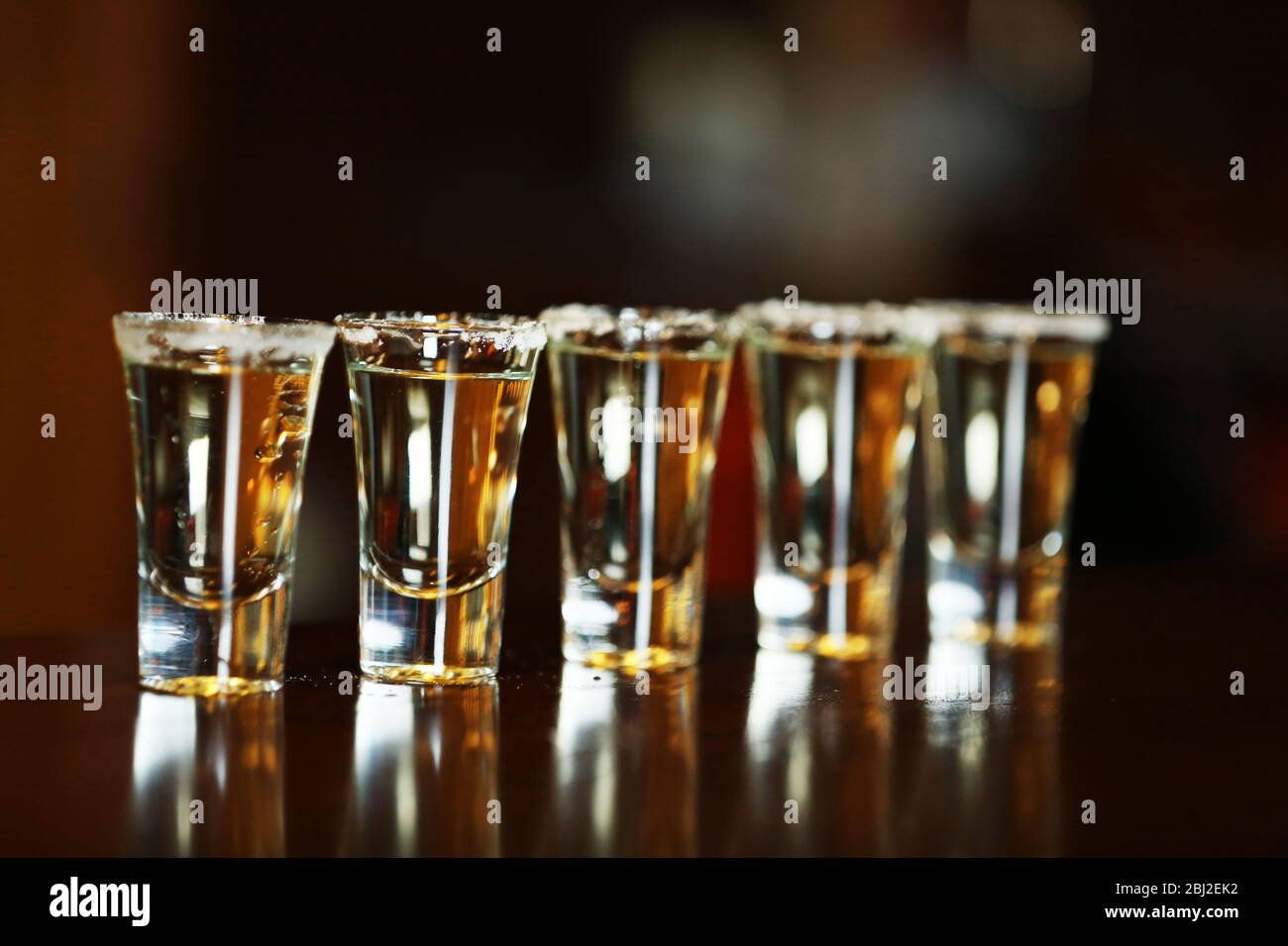 Shot glasses with tequila on bar counter Stock Photo - Alamy