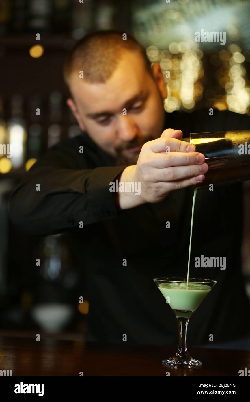 Bartender making cocktail Stock Photo - Alamy