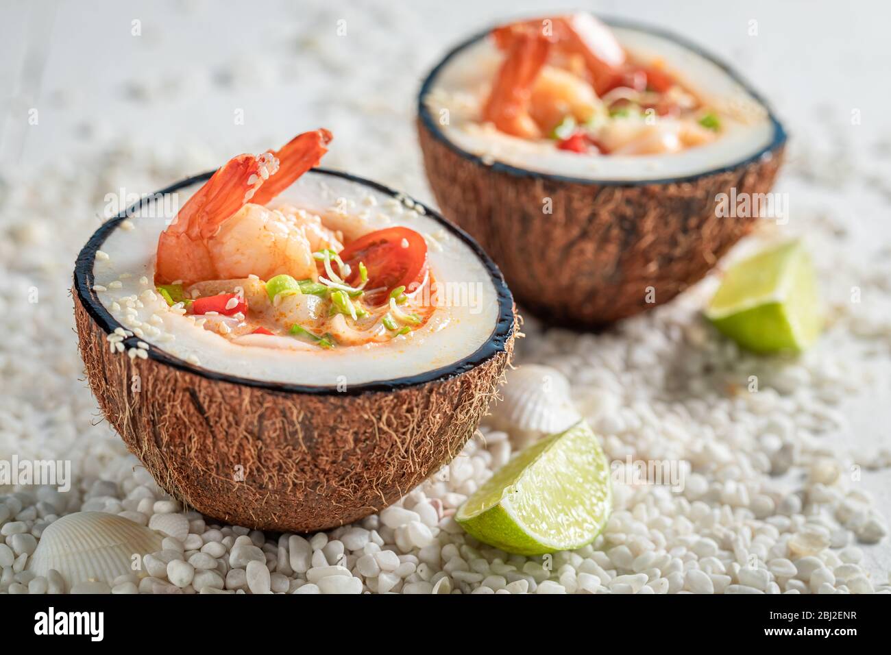 Fresh Tom Yum soup on white stones with seashells Stock Photo - Alamy