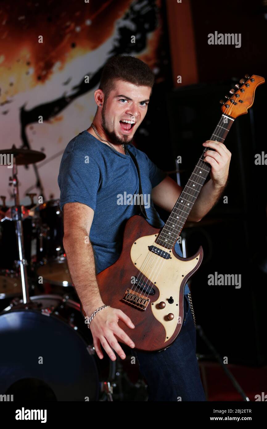 Young man playing on electric guitar at pub Stock Photo - Alamy