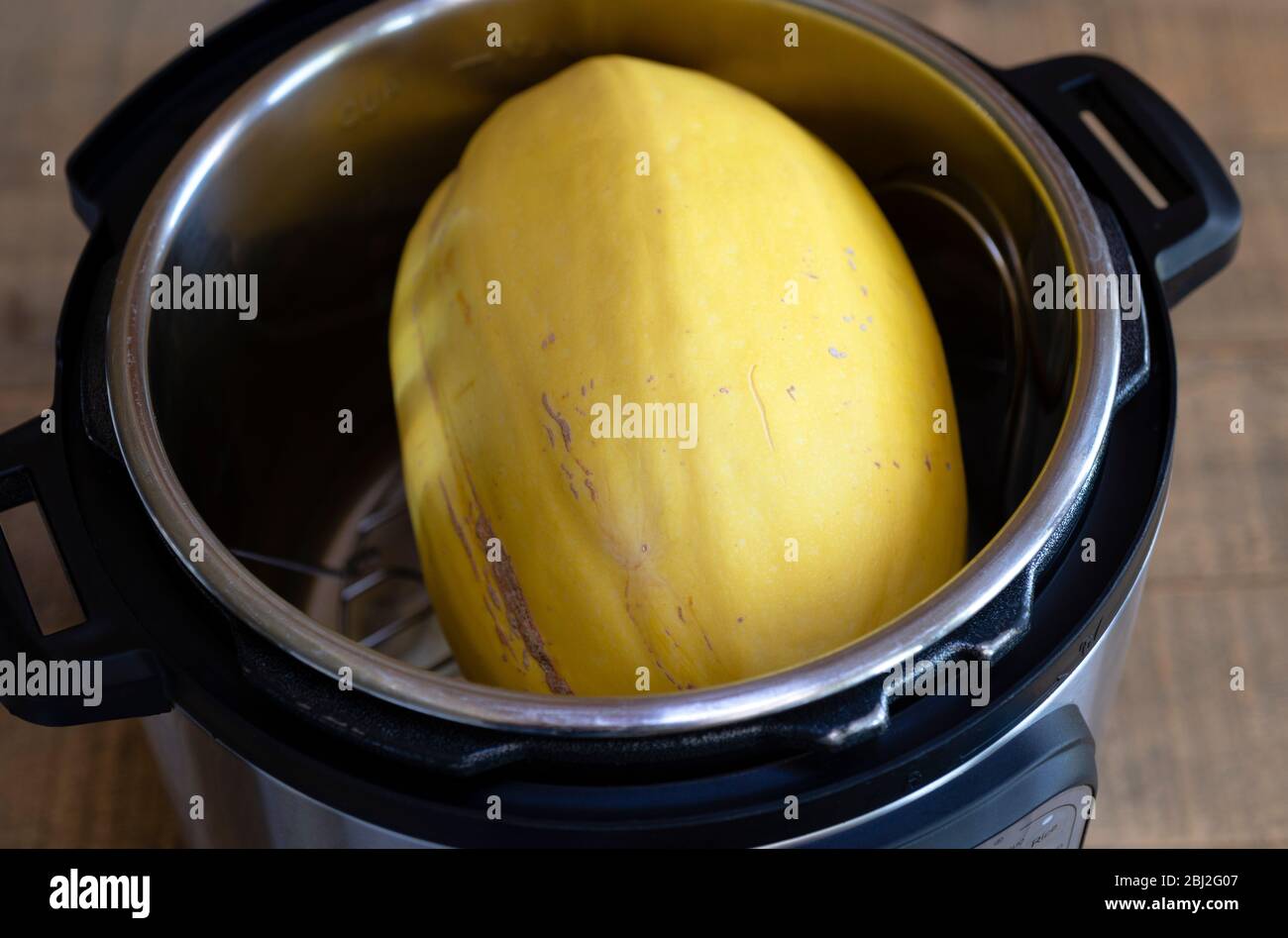 A whole spaghetti squash in an electric pressure cooker Stock Photo - Alamy