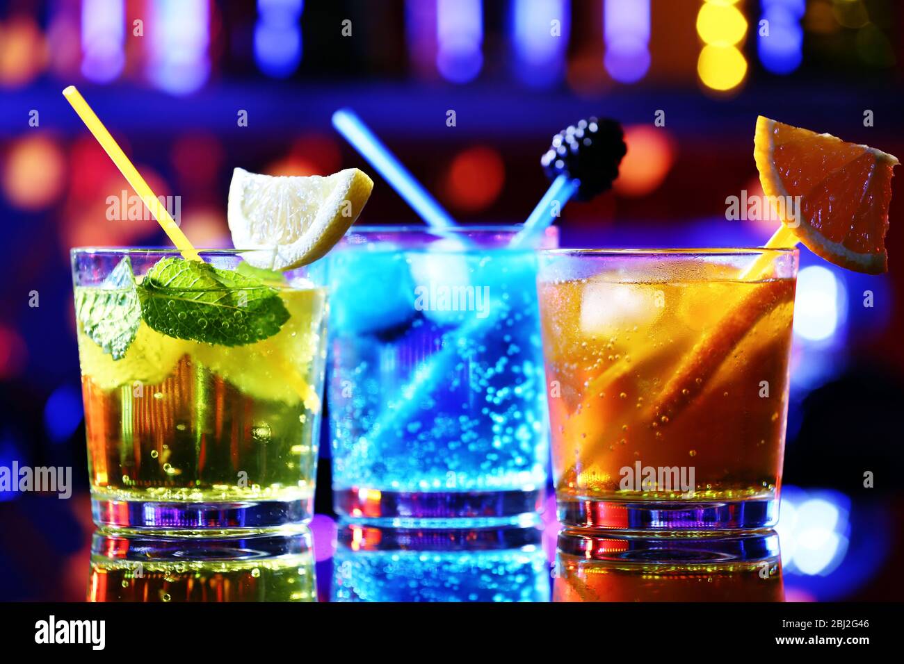 Glasses of cocktails on bar background Stock Photo - Alamy