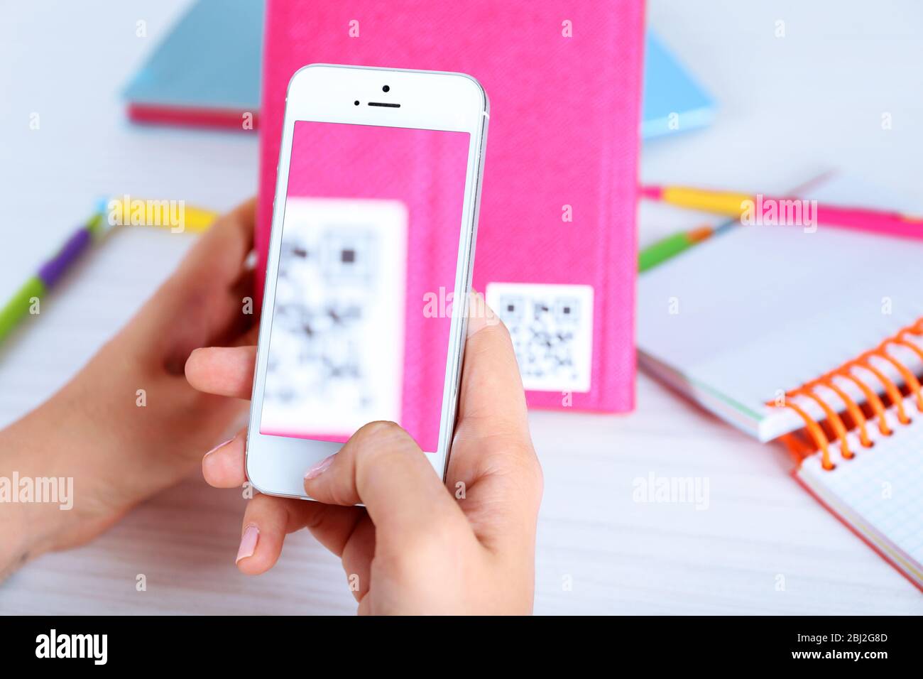 Woman scanning voucher code with mobile phone close up Stock Photo - Alamy