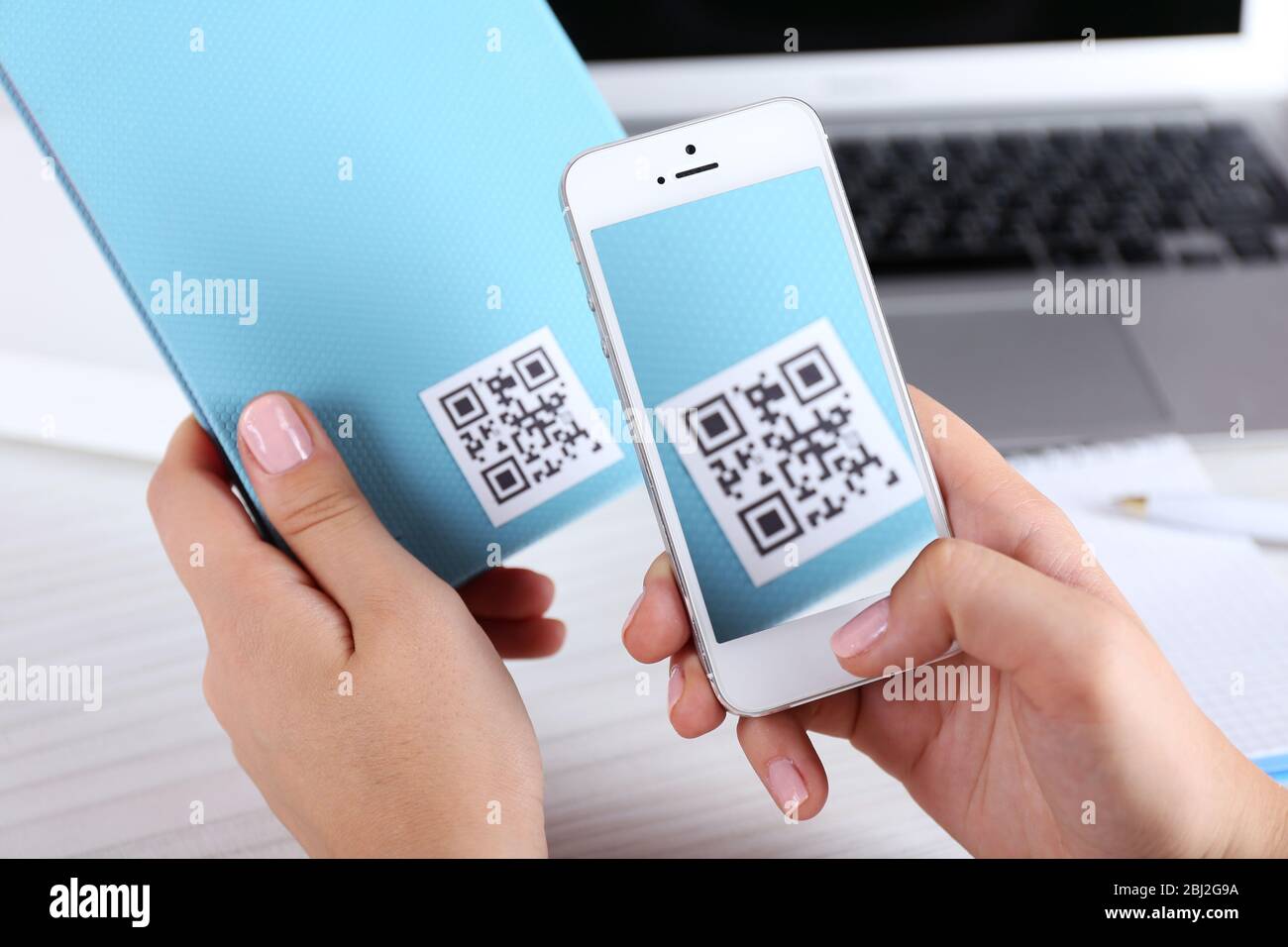 Woman scanning voucher code with mobile phone close up Stock Photo - Alamy