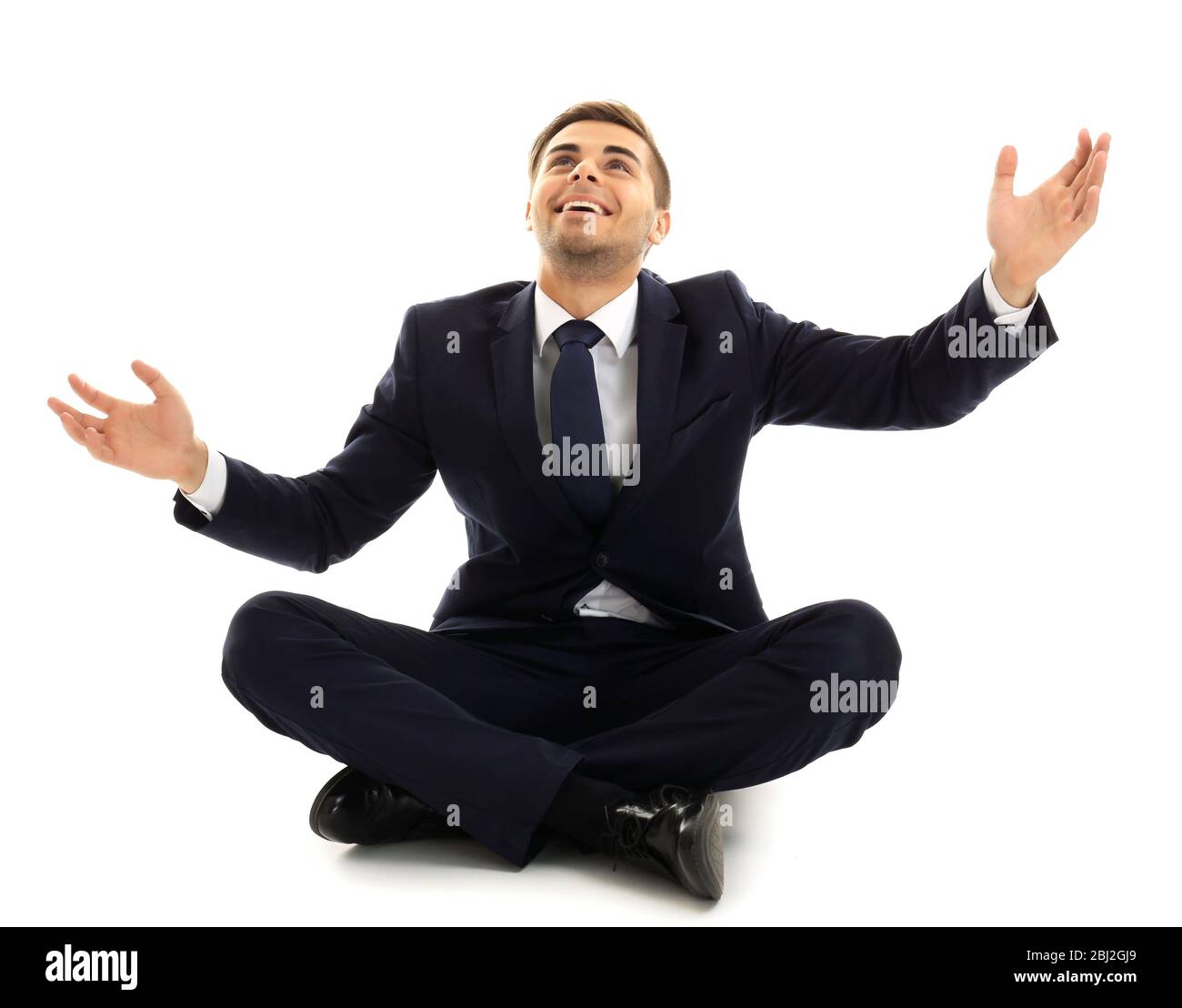 Elegant man in suit sitting isolated on white Stock Photo - Alamy