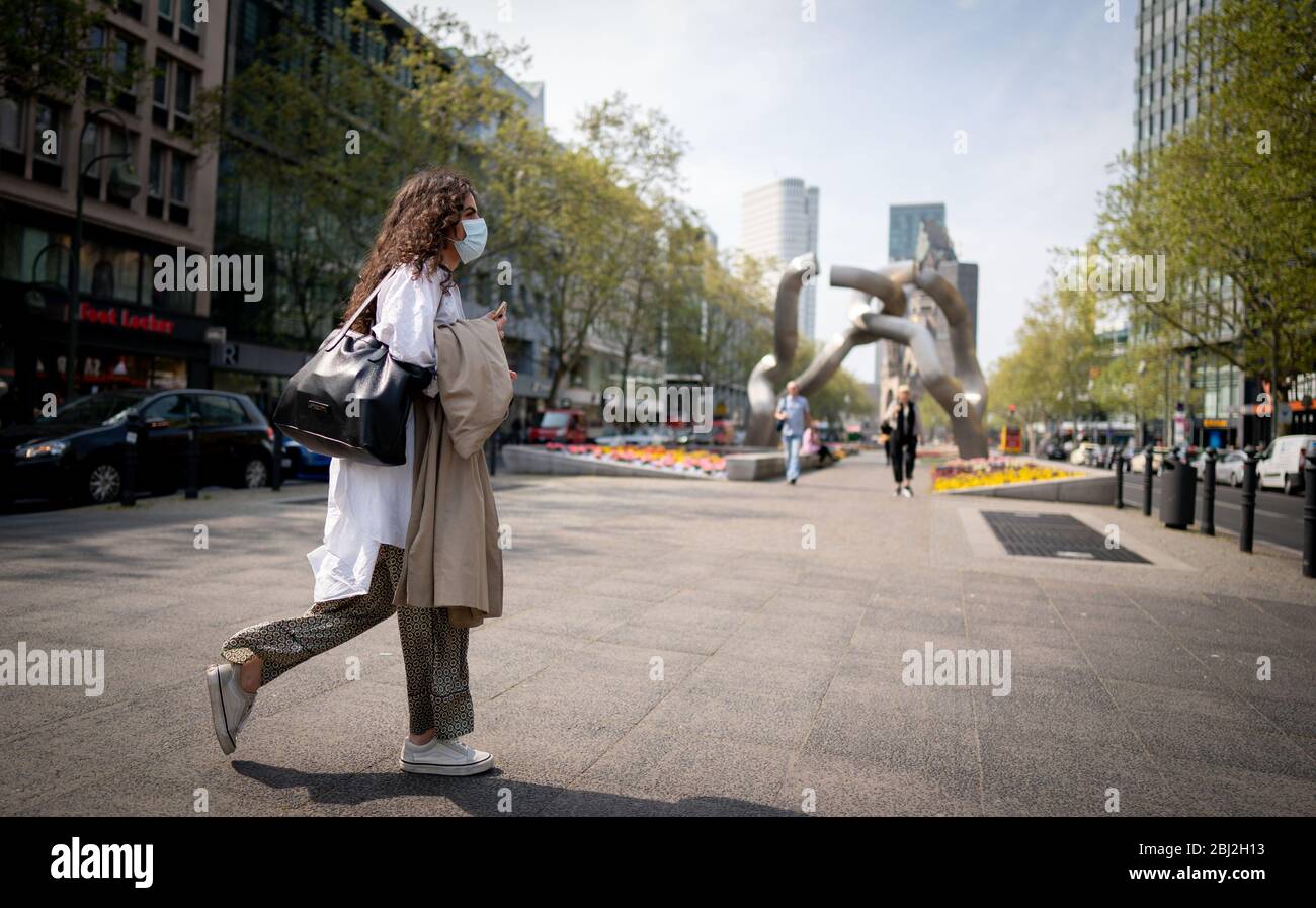 Berlin, Germany. 28th Apr, 2020. A passer-by with a mouth and nose ...