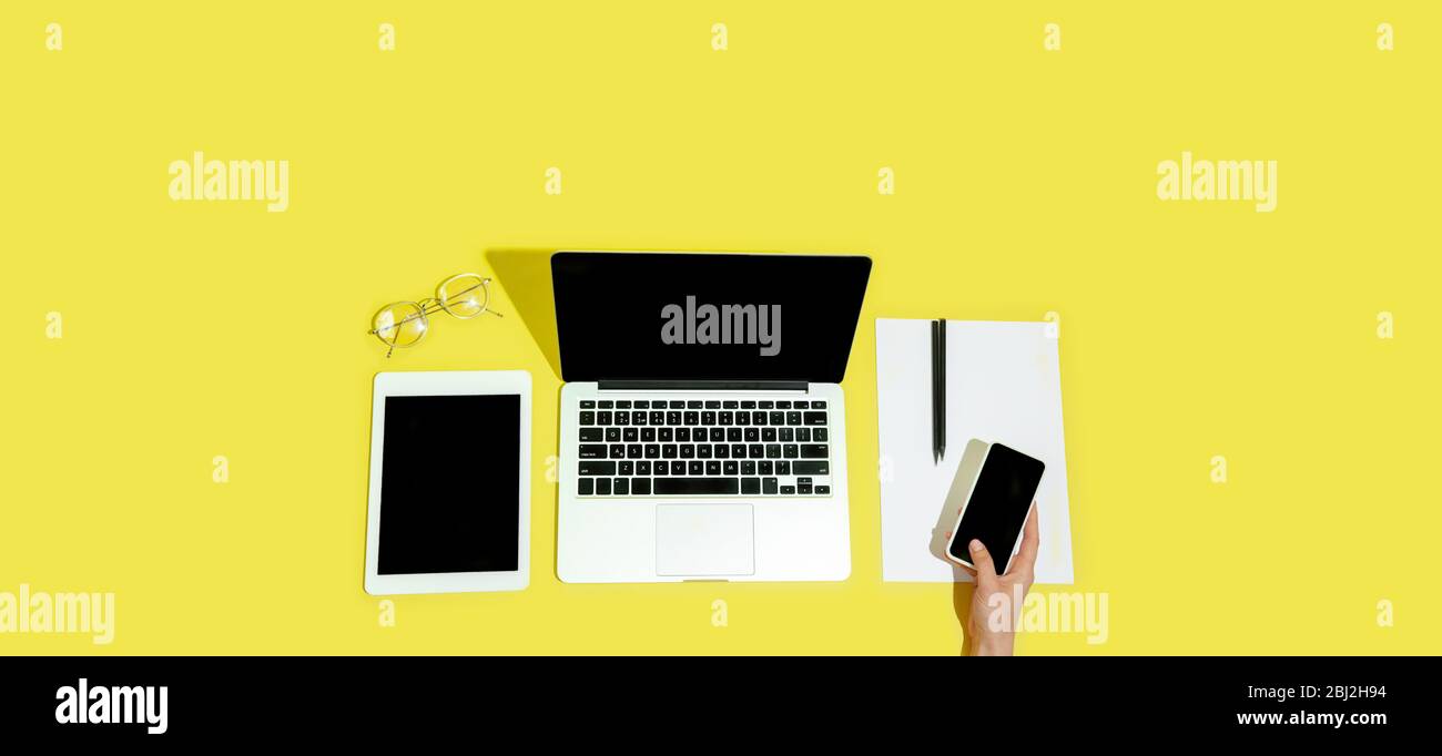 Hand using gadgets, devices on top view, blank screen with copyspace ...