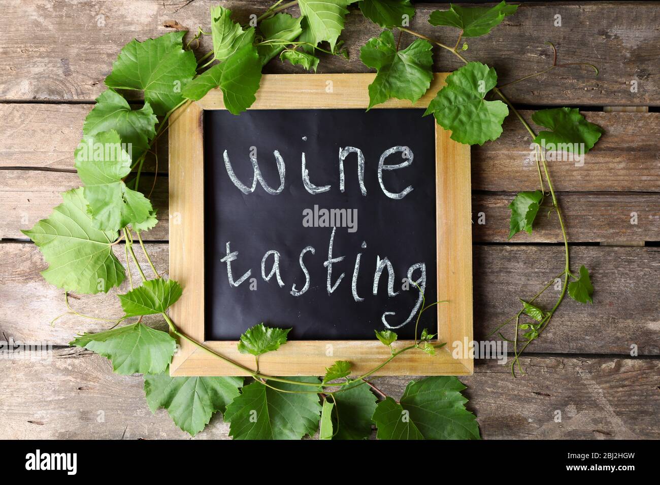 Old square chalk scripted frame with vine on wooden background Stock ...