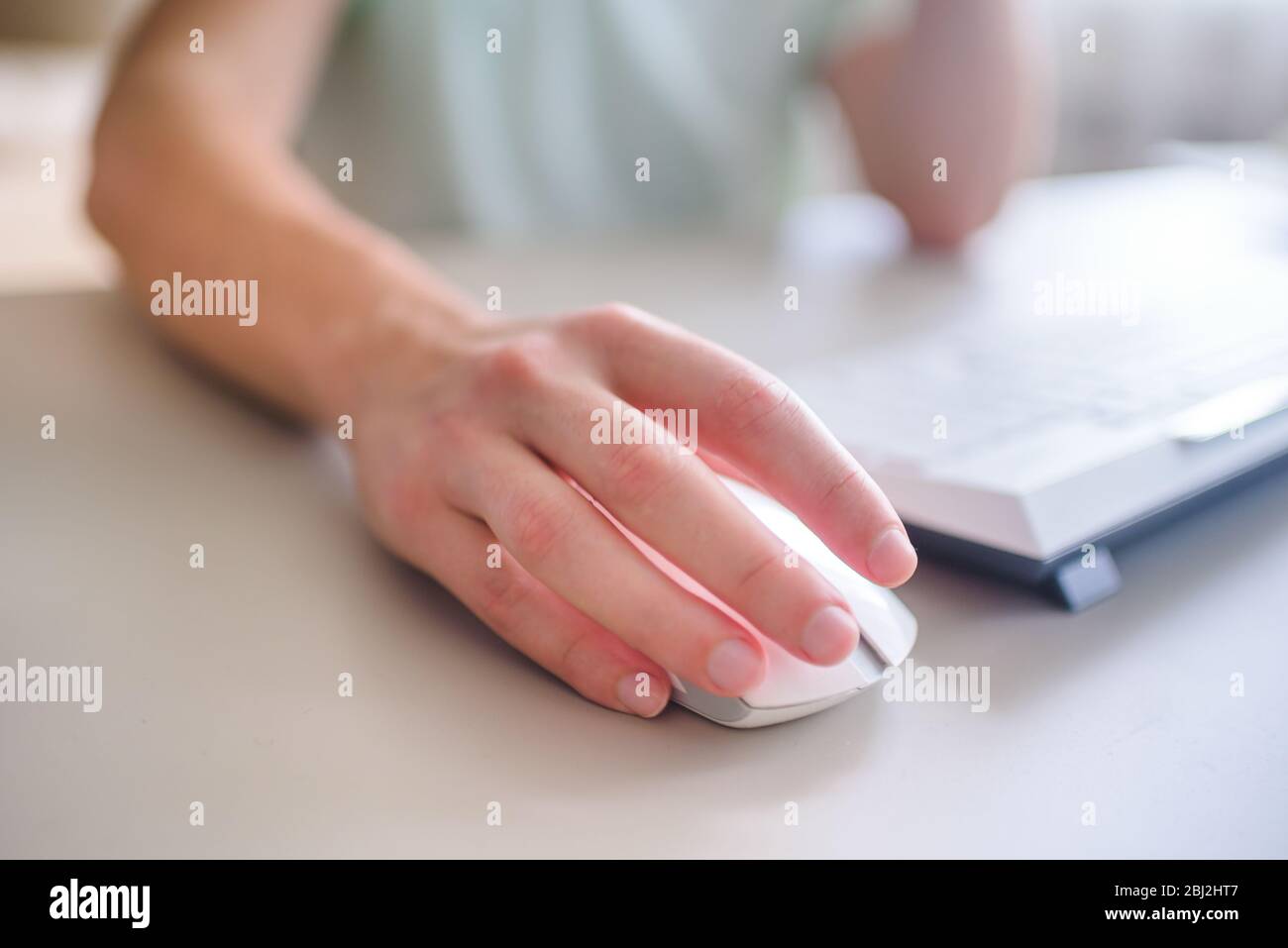 close up hand business man using mouse and laptop in office with ...