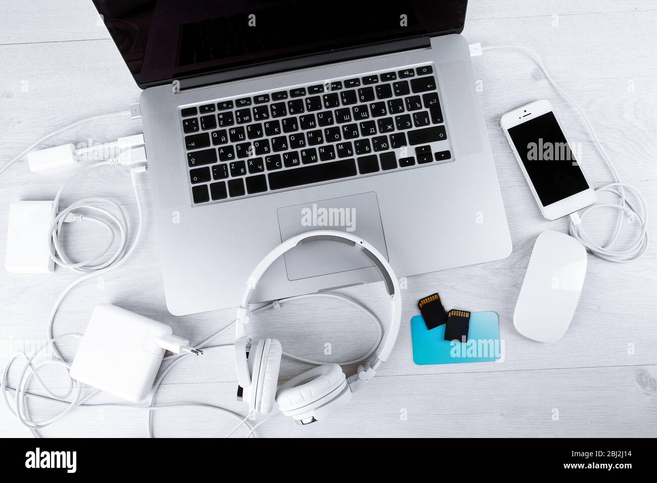 Computer peripherals and laptop accessories on white wooden background ...