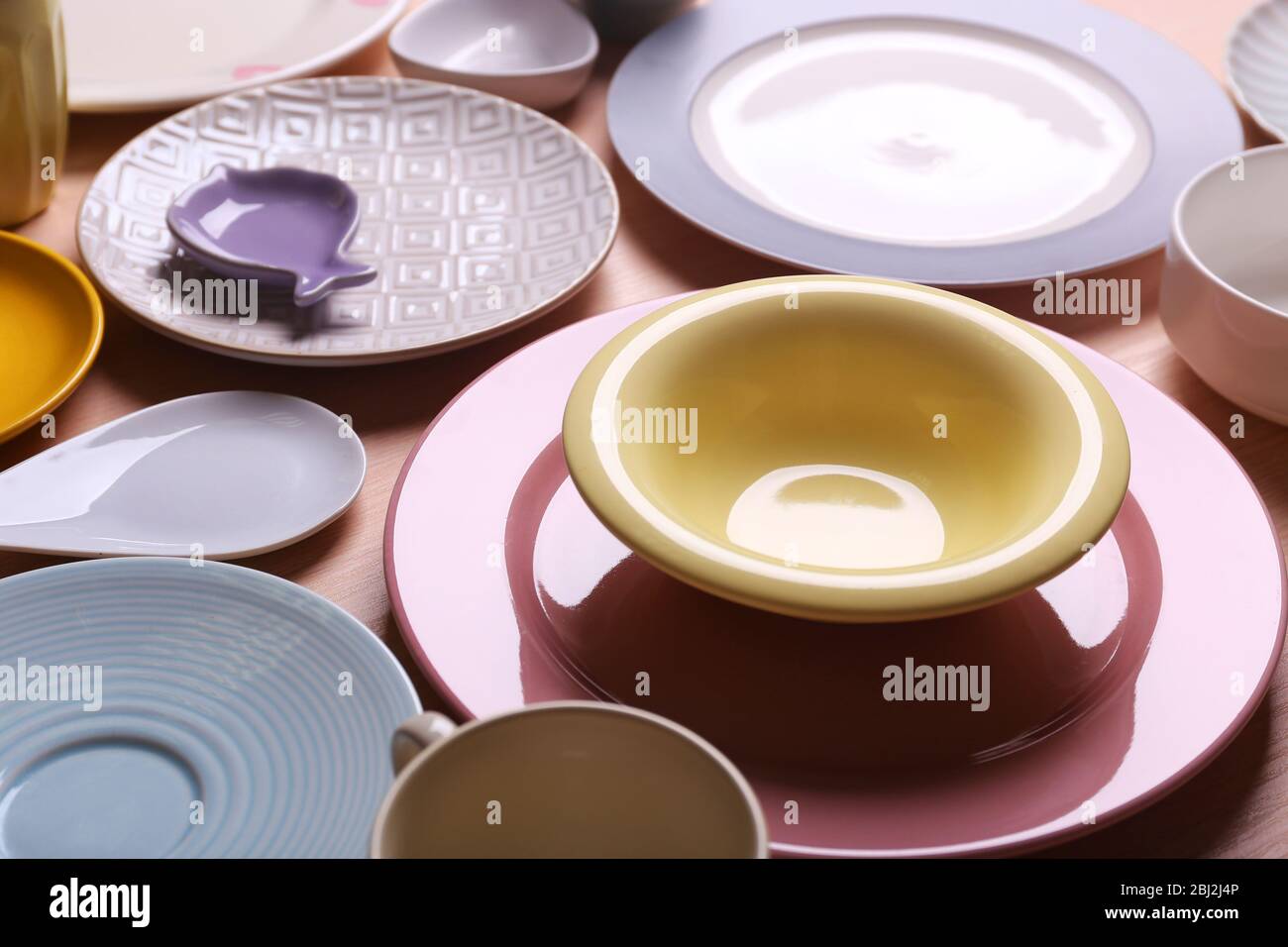Set of colour plates on rose background Stock Photo - Alamy