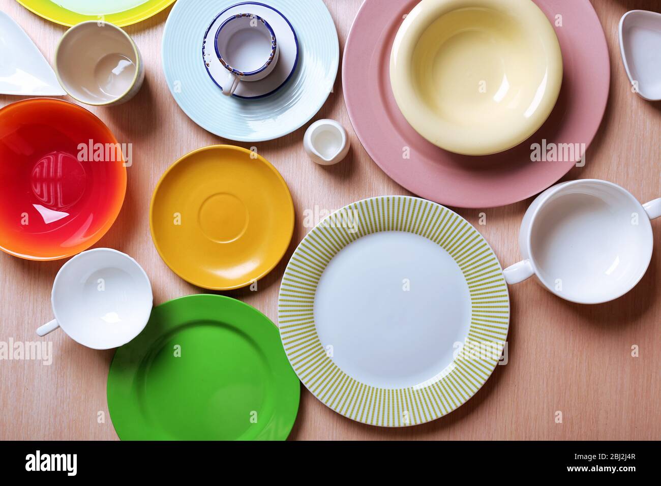 Set of colourful plates on the table Stock Photo - Alamy
