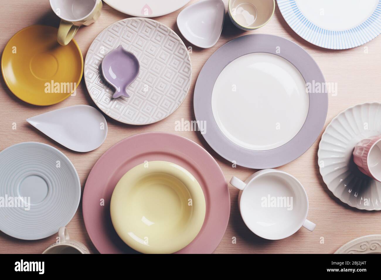 Set of colour plates on rose background Stock Photo - Alamy
