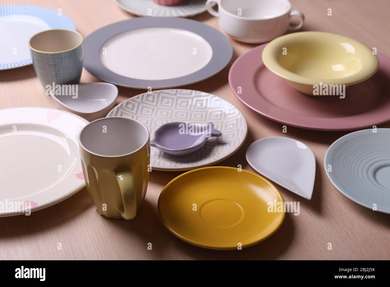 Set of colour plates on rose background Stock Photo - Alamy