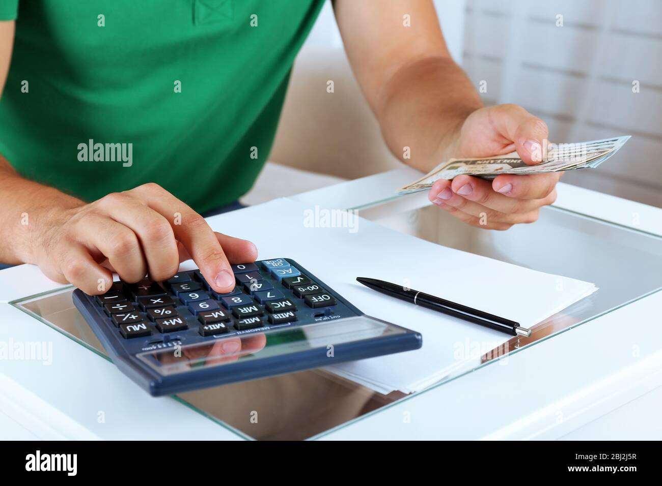Calculating money, close up Stock Photo - Alamy