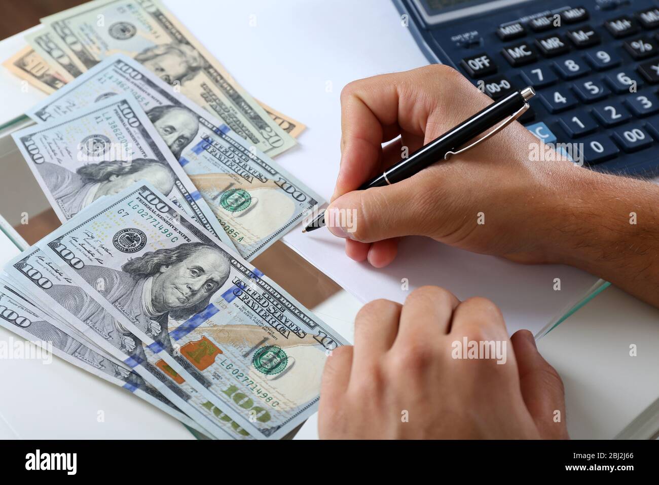 Calculating money, close up Stock Photo - Alamy
