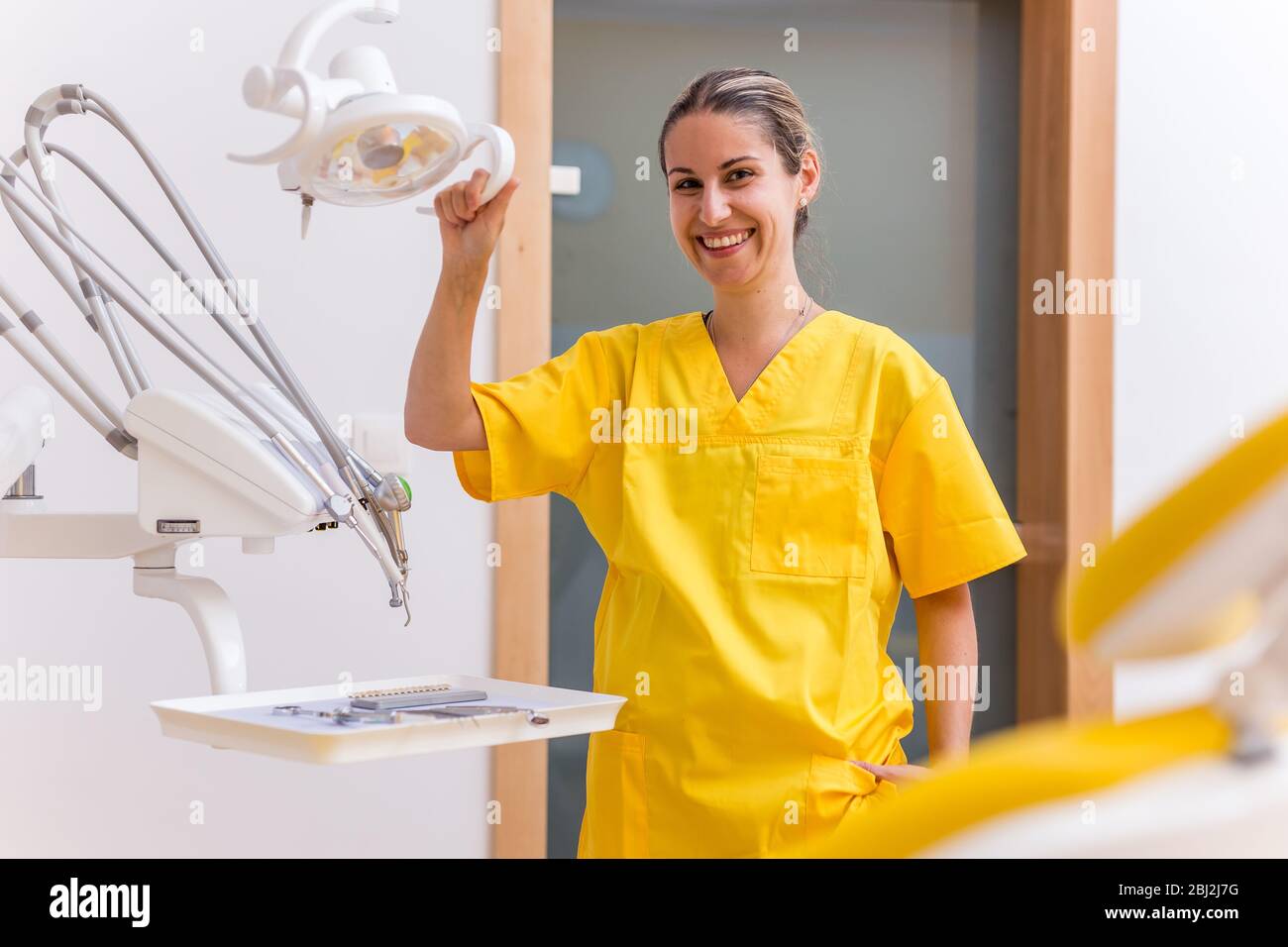 Portrait of young blonde dentist at dentistry or clinic weared in ...