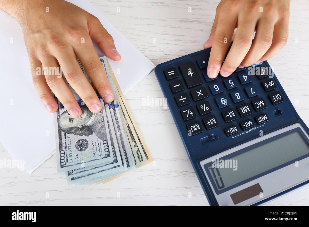Calculating money, close up Stock Photo - Alamy