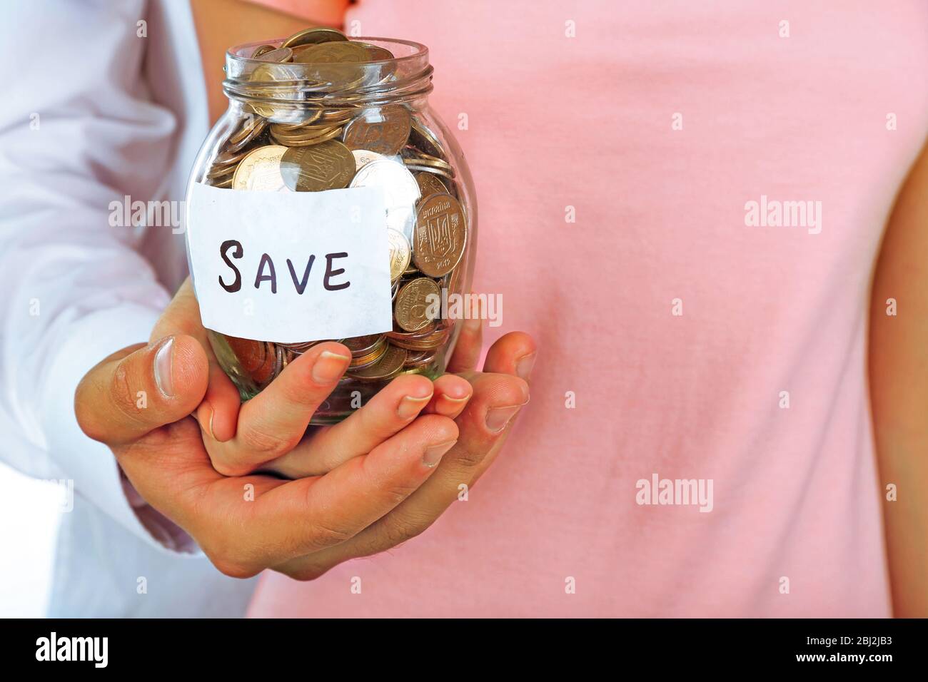 Man and woman hands holding savings bank Stock Photo - Alamy