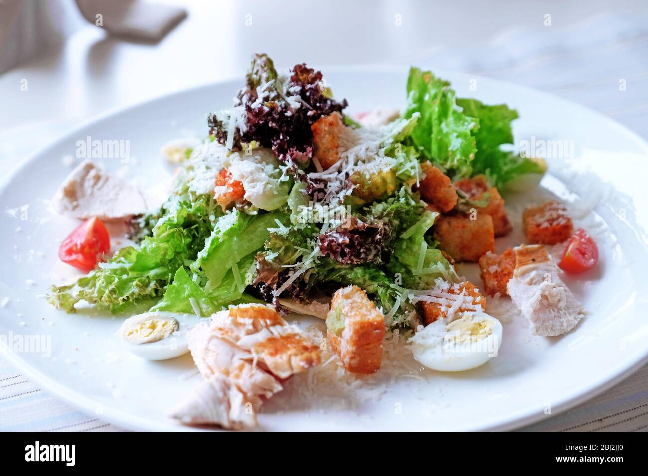 Caesar salad on table in cafe Stock Photo - Alamy