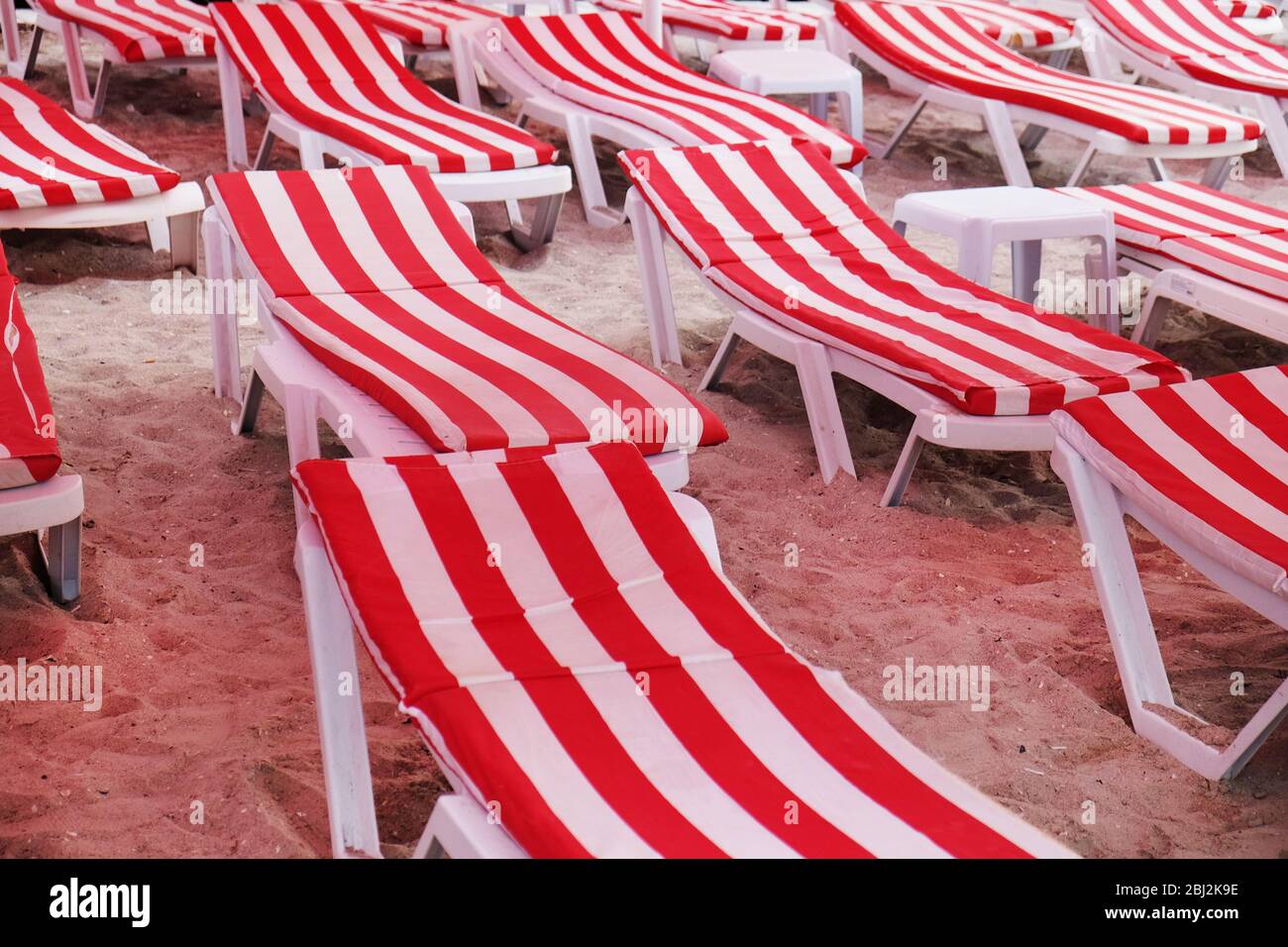 Red sunbeds on sea beach in resort Stock Photo - Alamy