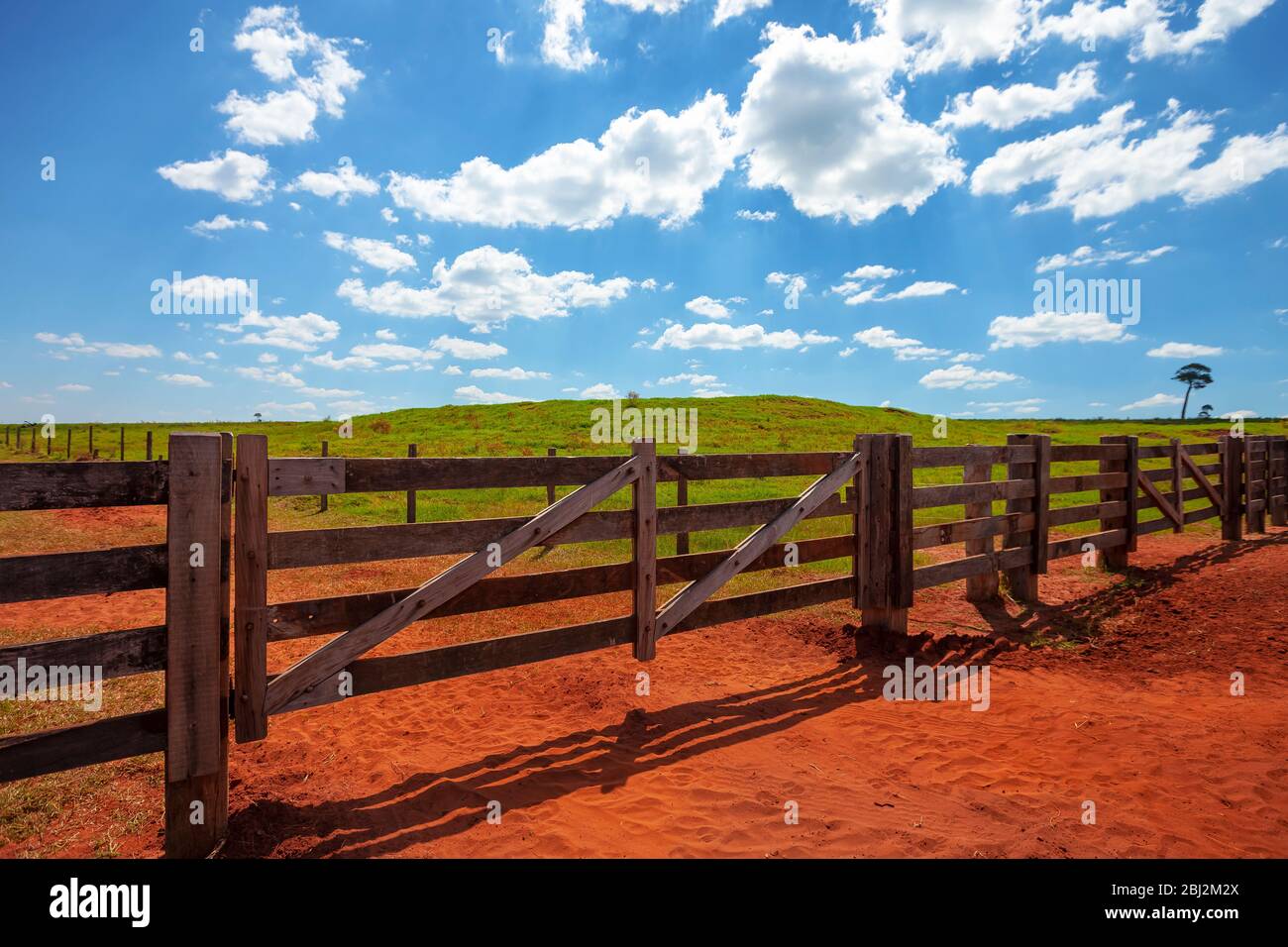 closed farm gate under blue sky with clouds Stock Photo - Alamy