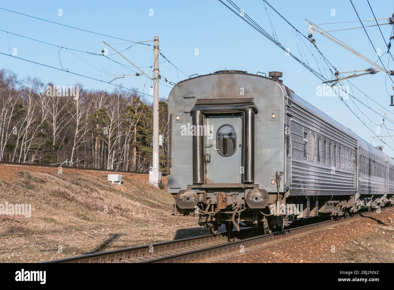 Last carriage of the passenger intercity train moves Stock Photo - Alamy