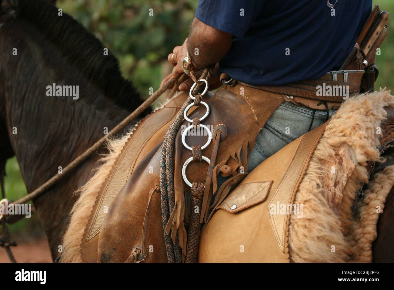 detail of cowboy outfit mounted on horse saddle Stock Photo - Alamy