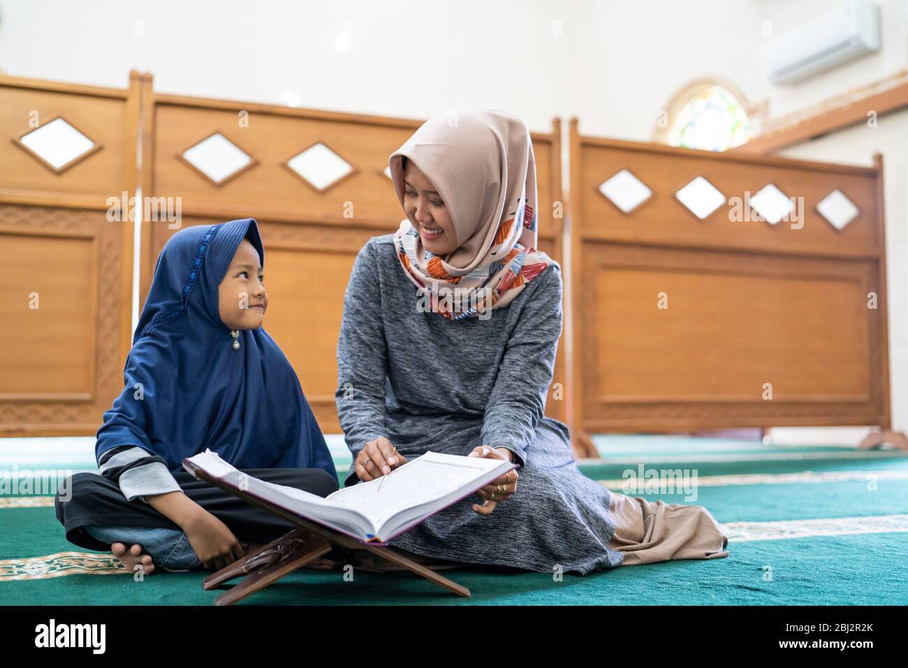 muslim young female teacher teach her student to read quran in the ...