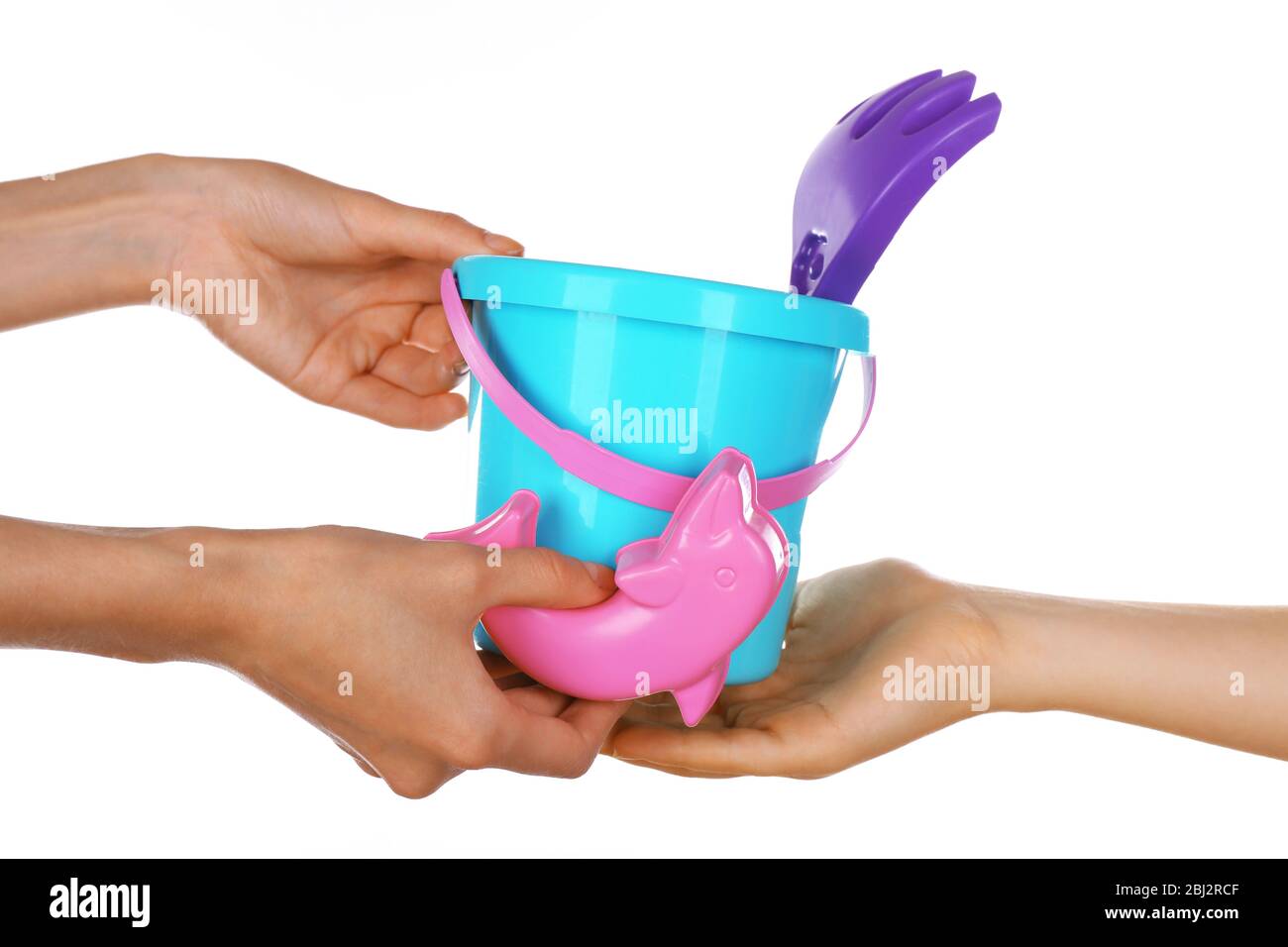 Concept of childish goods sale -one woman hand gives toys to another ...