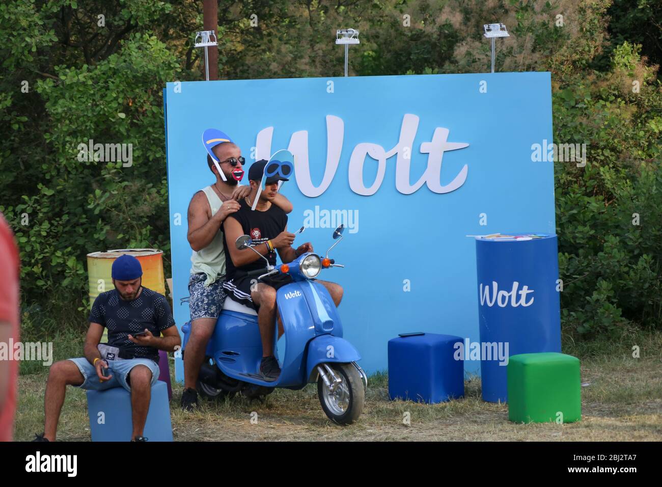 Audience with hands raised at a music festival and lights streaming ...