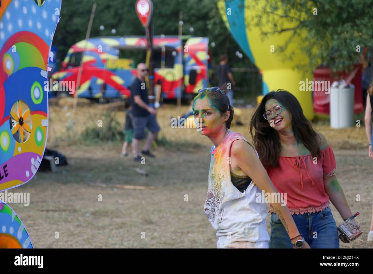 Audience with hands raised at a music festival and lights streaming ...