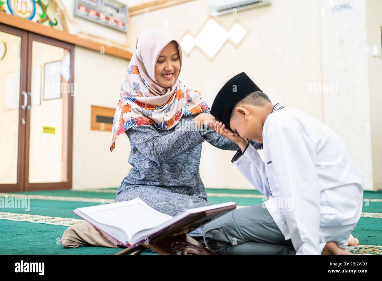 muslim kid pay respect to his teacher before studying in the mosque ...