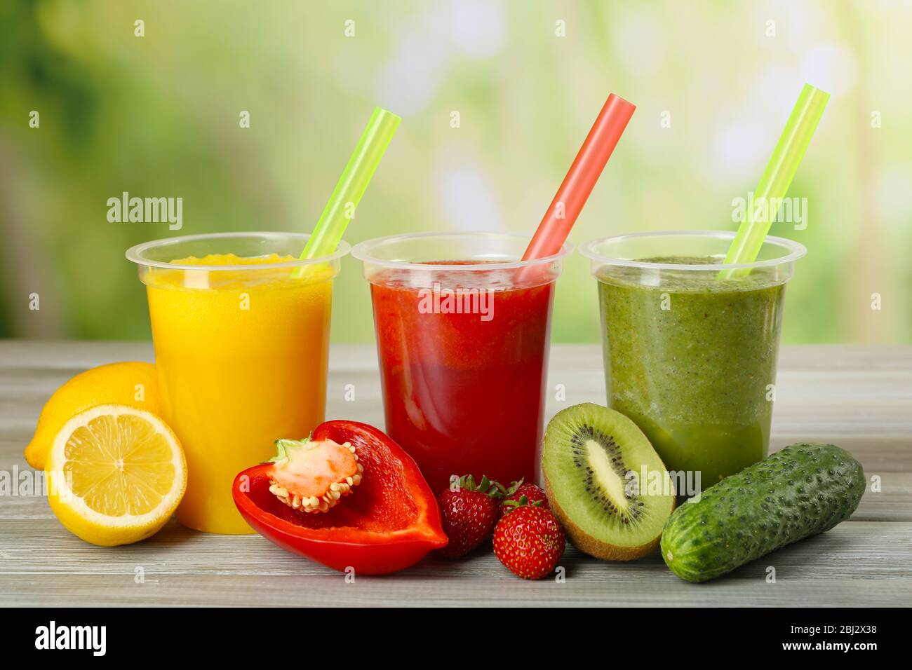 Fresh juice mix fruit, healthy drinks on wooden table, on bright ...