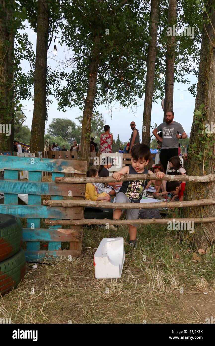Audience with hands raised at a music festival and lights streaming ...