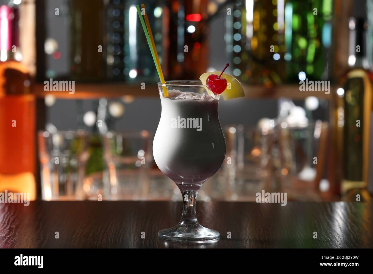Cocktail decorated with cherry and pineapple on the bar counter, close ...