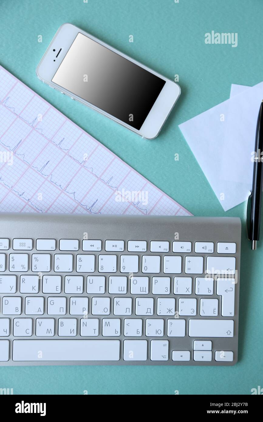 Medical still life with keyboard on blue table Stock Photo - Alamy