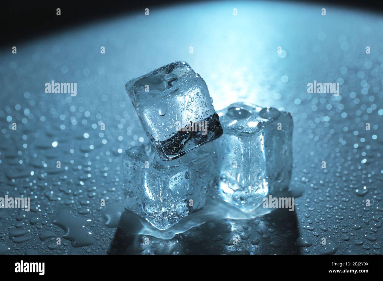 Melting ice cubes under blue light, close up Stock Photo - Alamy