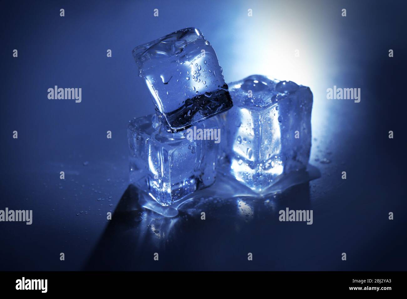 Ice cubes under blue light, close up Stock Photo - Alamy