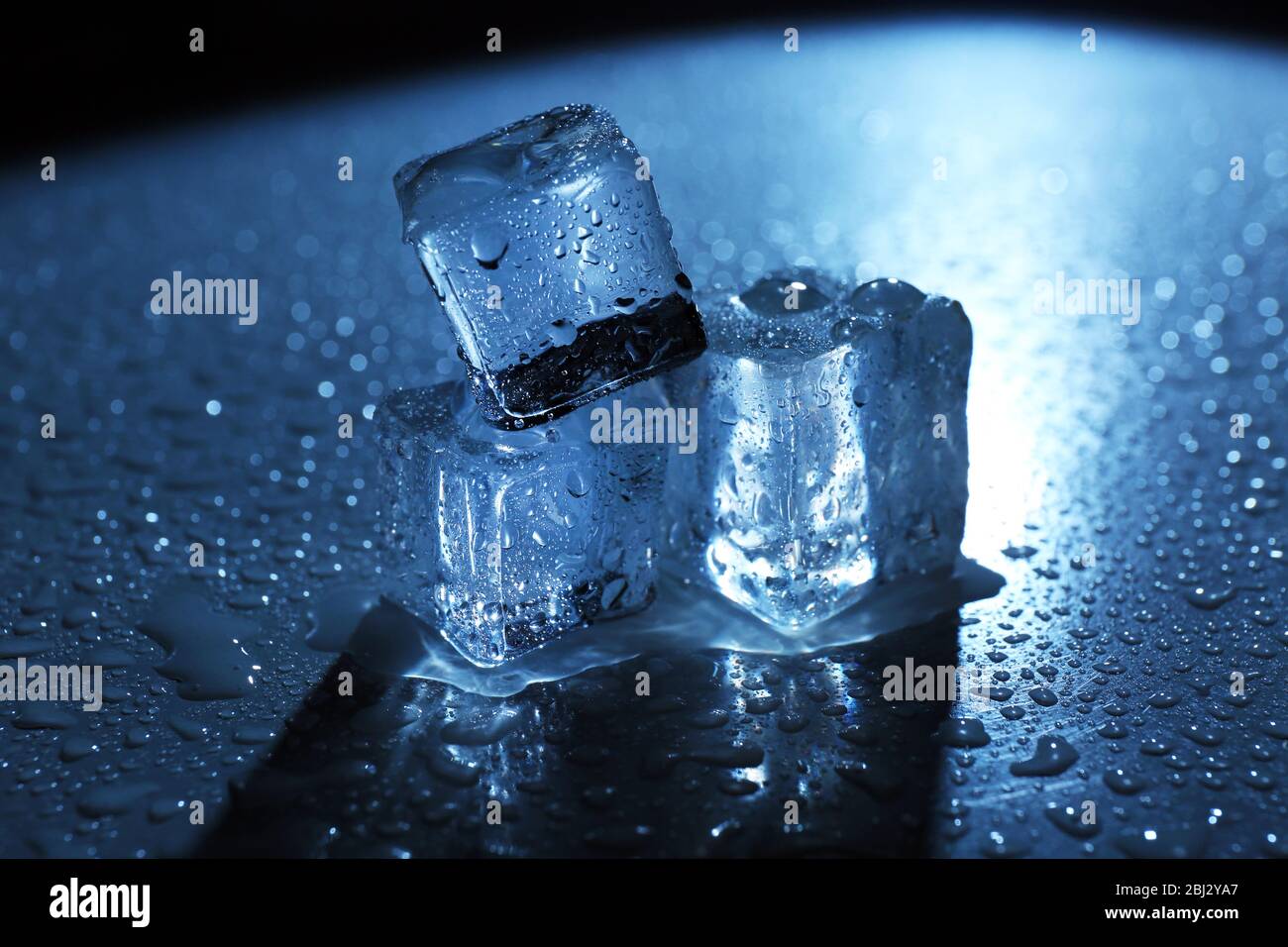 Melting ice cubes under blue light, close up Stock Photo - Alamy