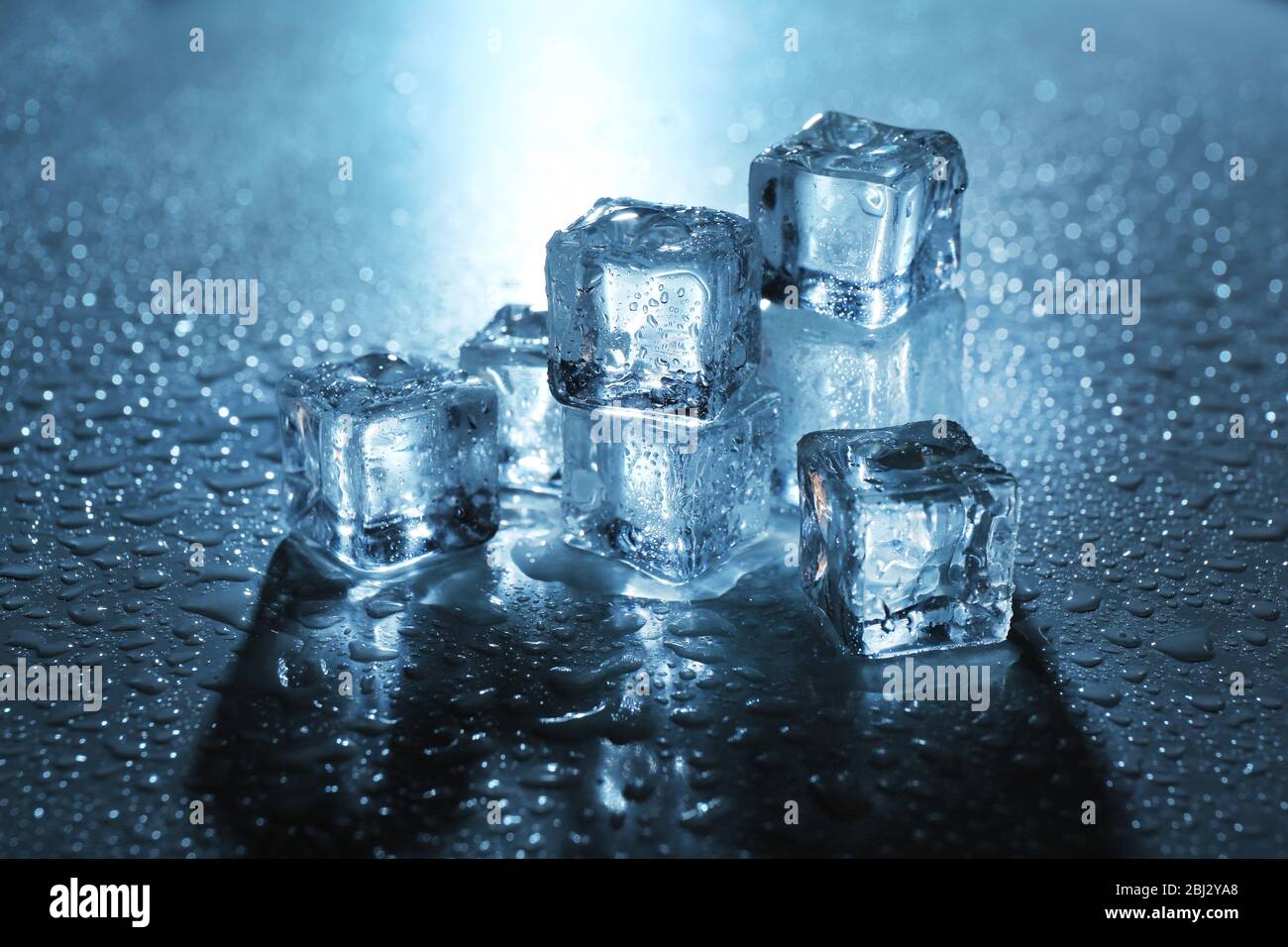 Melting ice cubes under blue light, close up Stock Photo - Alamy