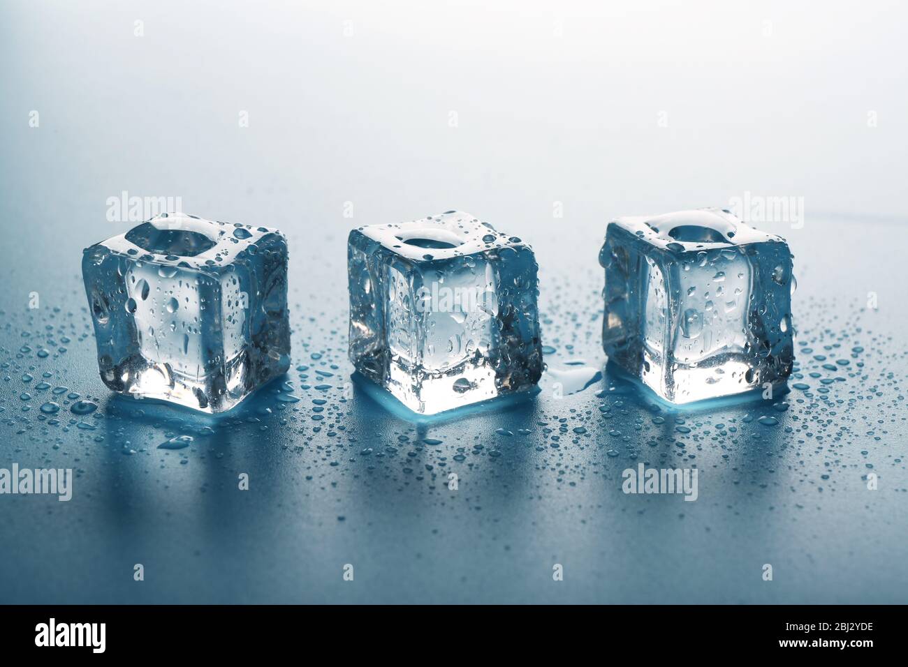 Perfect ice cubes in a row on grey background, close up Stock Photo - Alamy